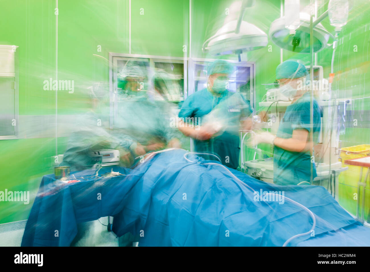 Zoom blurred image of a surgery procedure in modern hospital in blue ...