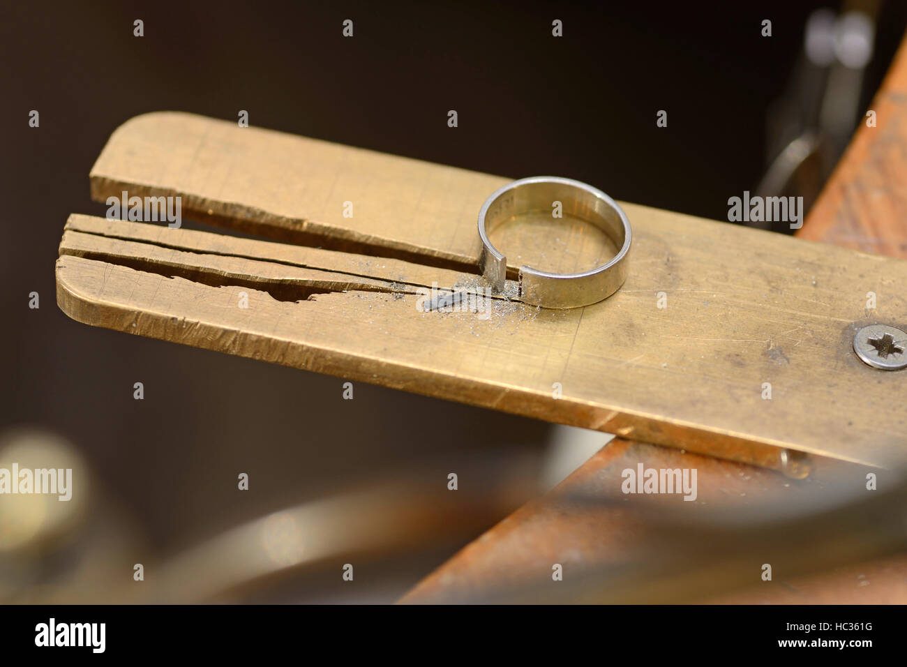 A gold ring cut and ready to be made smaller Stock Photo - Alamy