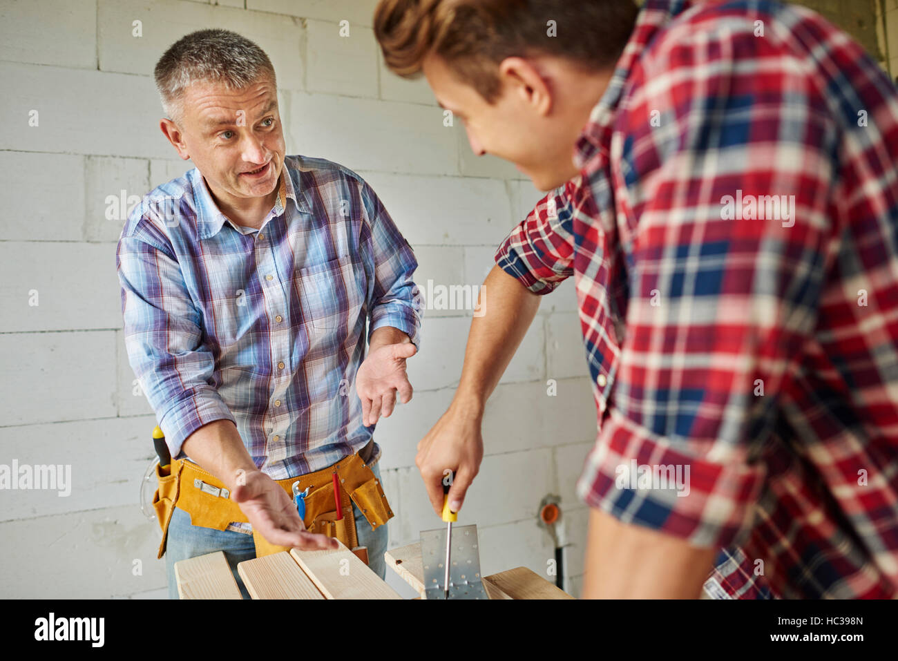 Confident young carpenter doing his job Stock Photo - Alamy