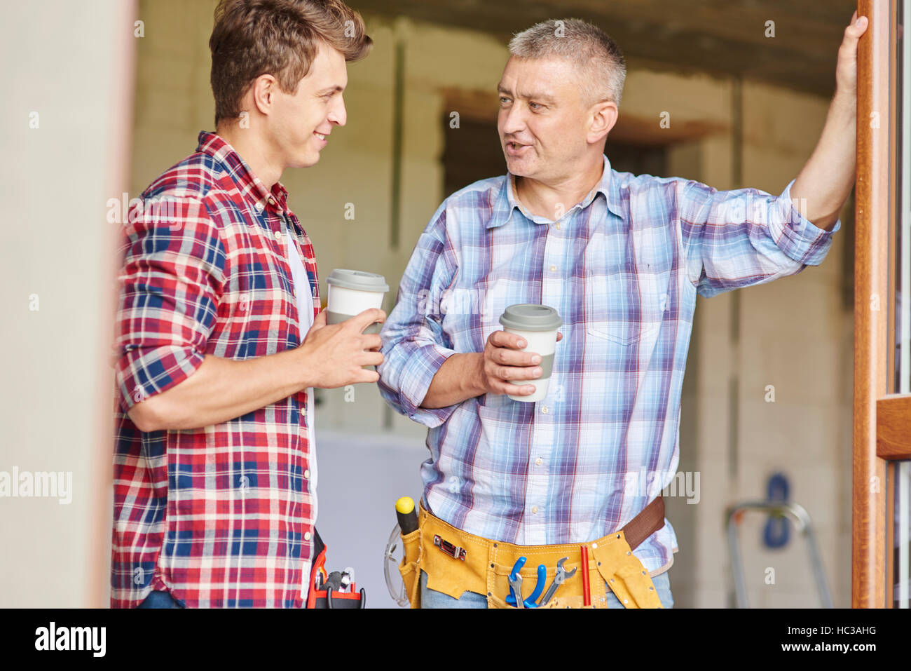 Little chat while having cup of coffee Stock Photo - Alamy