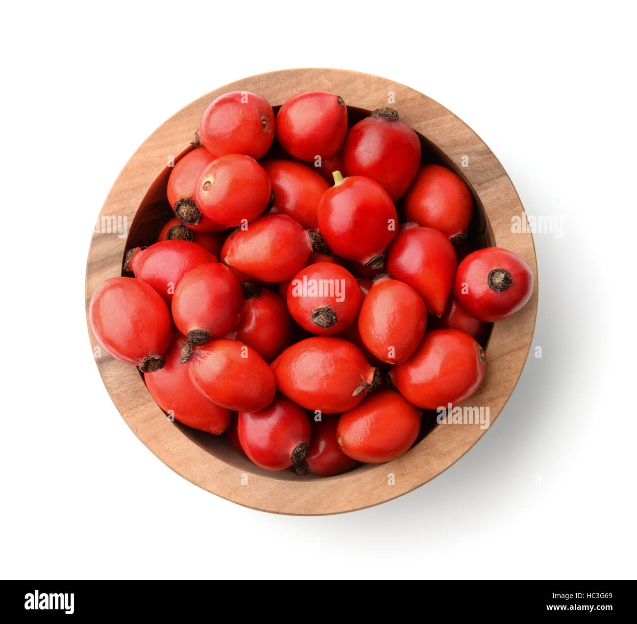 Top view of rose hips in bowl isolated on white Stock Photo - Alamy