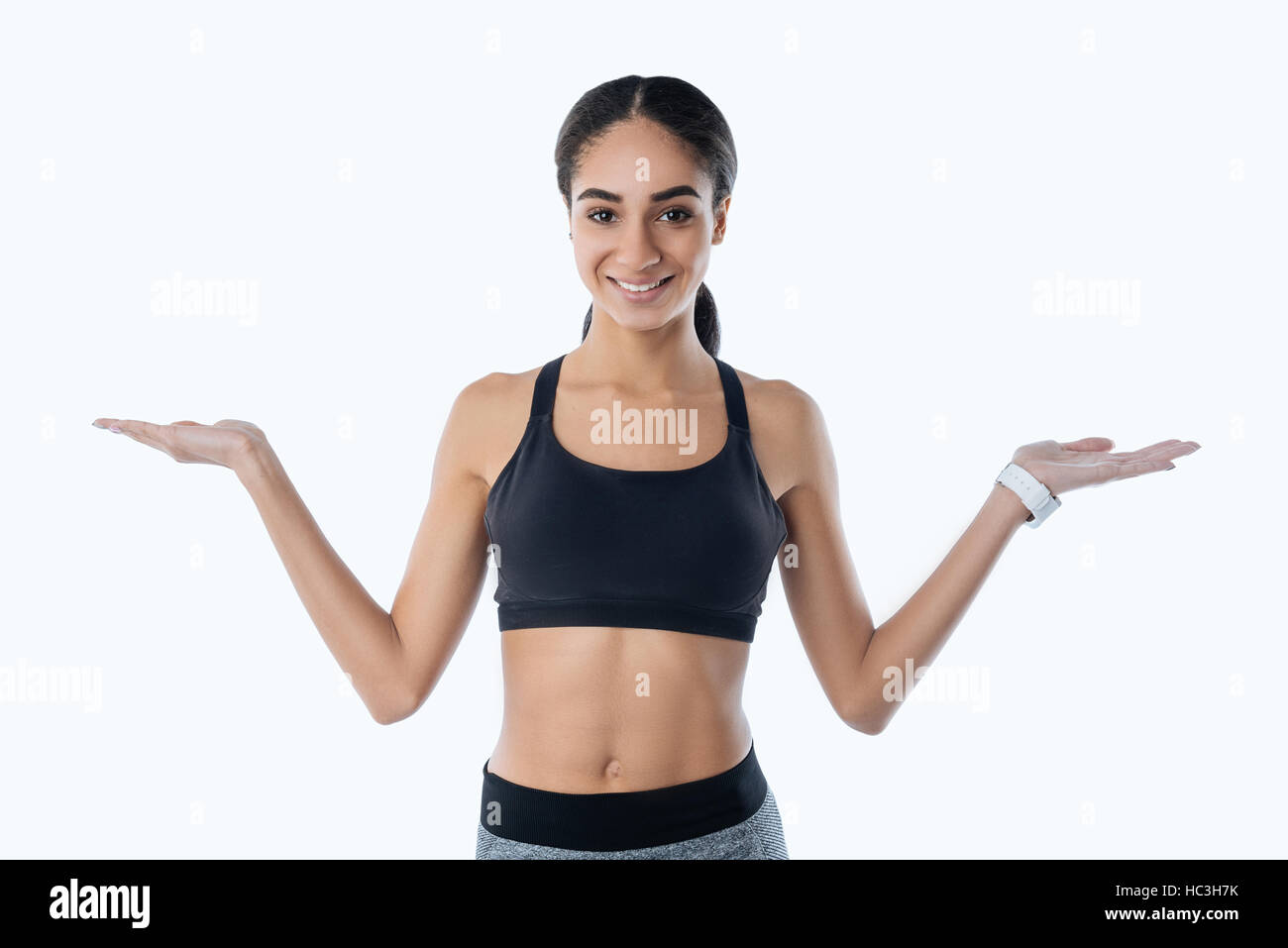 Positive delighted girl holding her hands up Stock Photo - Alamy