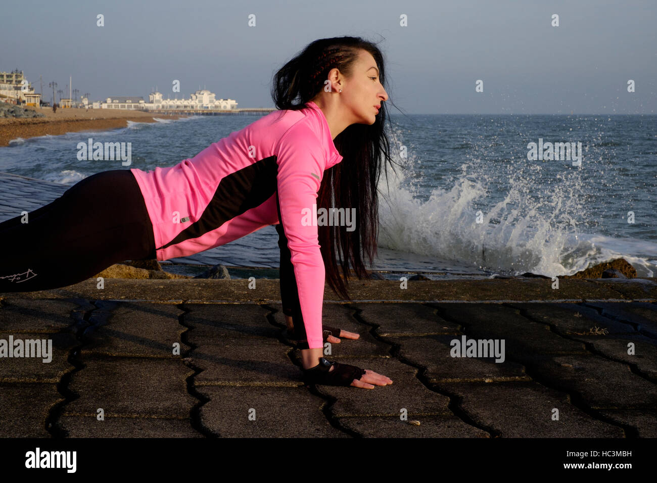a young female exercising during her daily keep fit routine outdoors ...