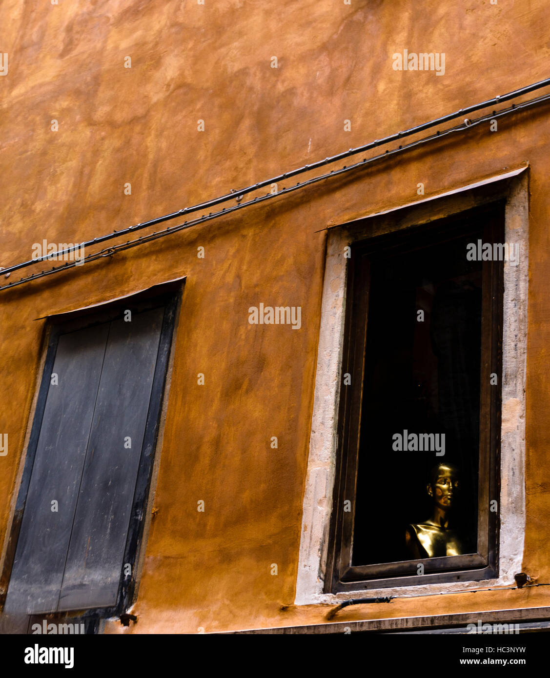 A golden bust in a window in Venice, Italy Stock Photo - Alamy