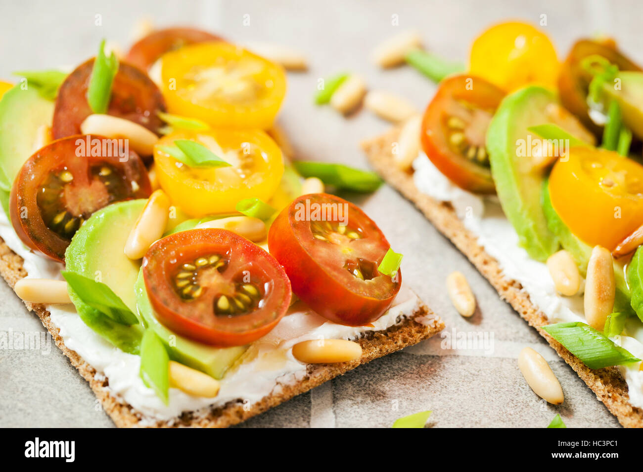 Healthy rye crisp bread toast with cream cheese, fresh avocado, cherry ...