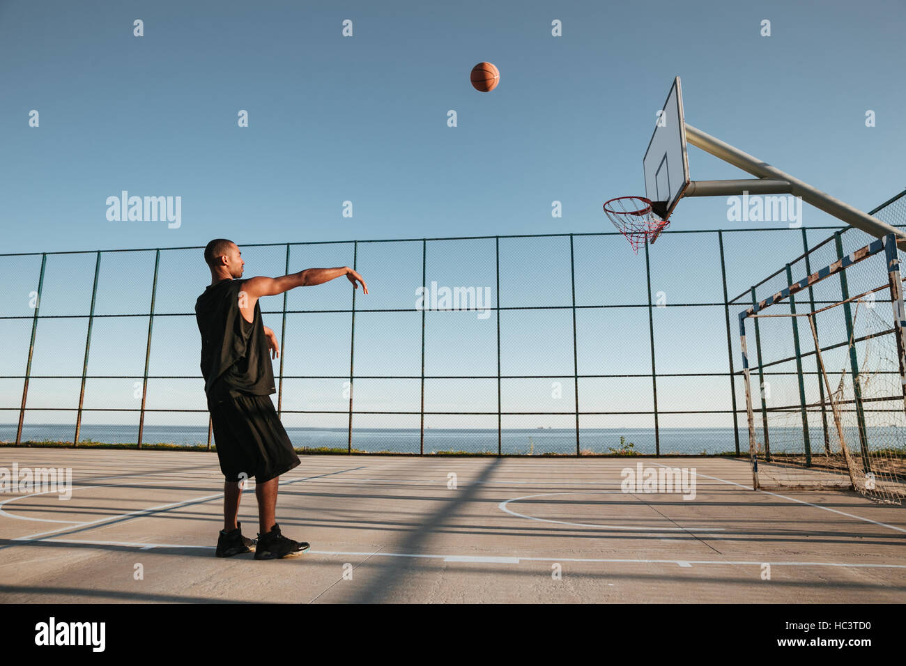 Young afro american basketball player scoring a point Stock Photo - Alamy
