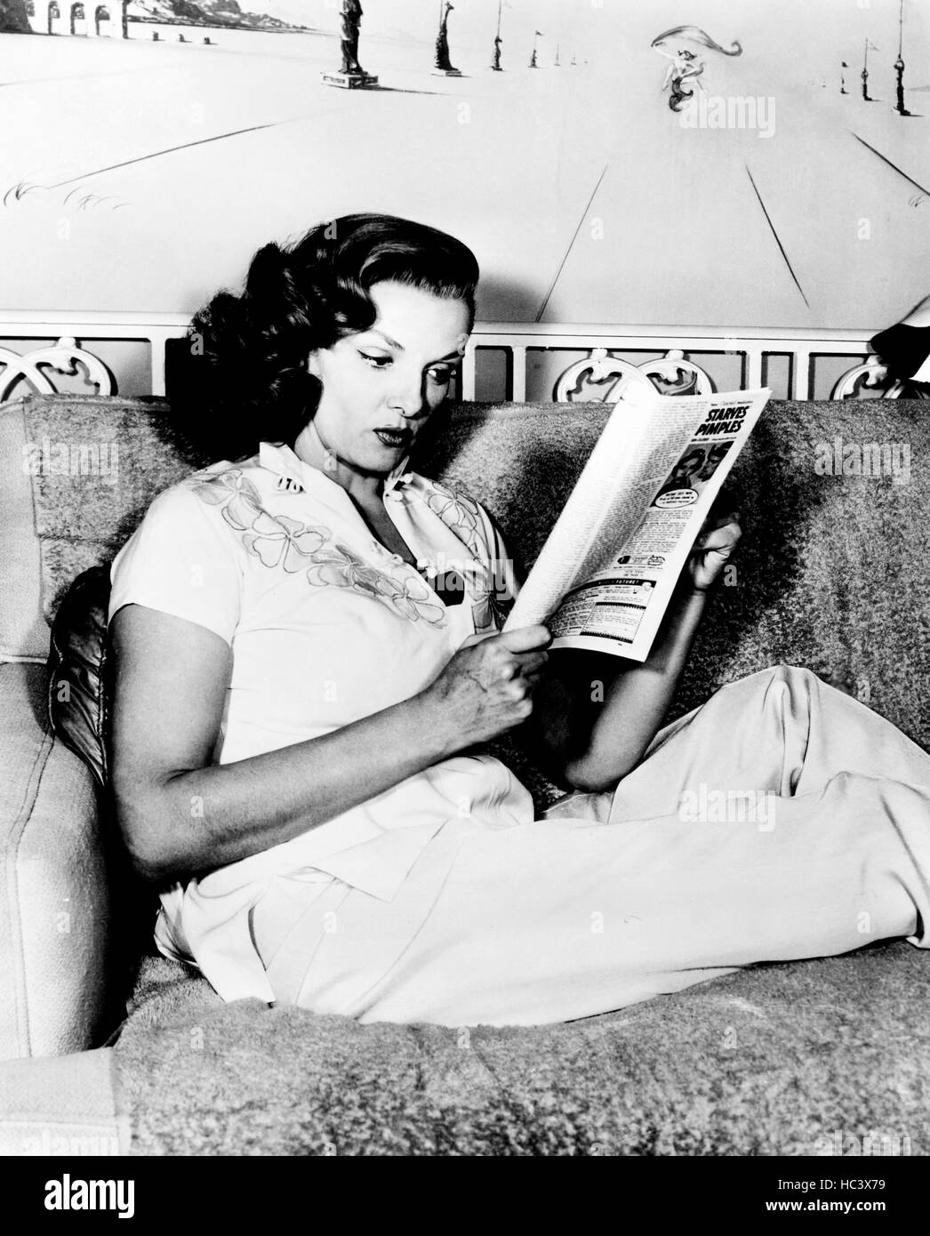 THE REVOLT OF MAMIE STOVER, Jane Russell relaxing on set, 1956. TM ...