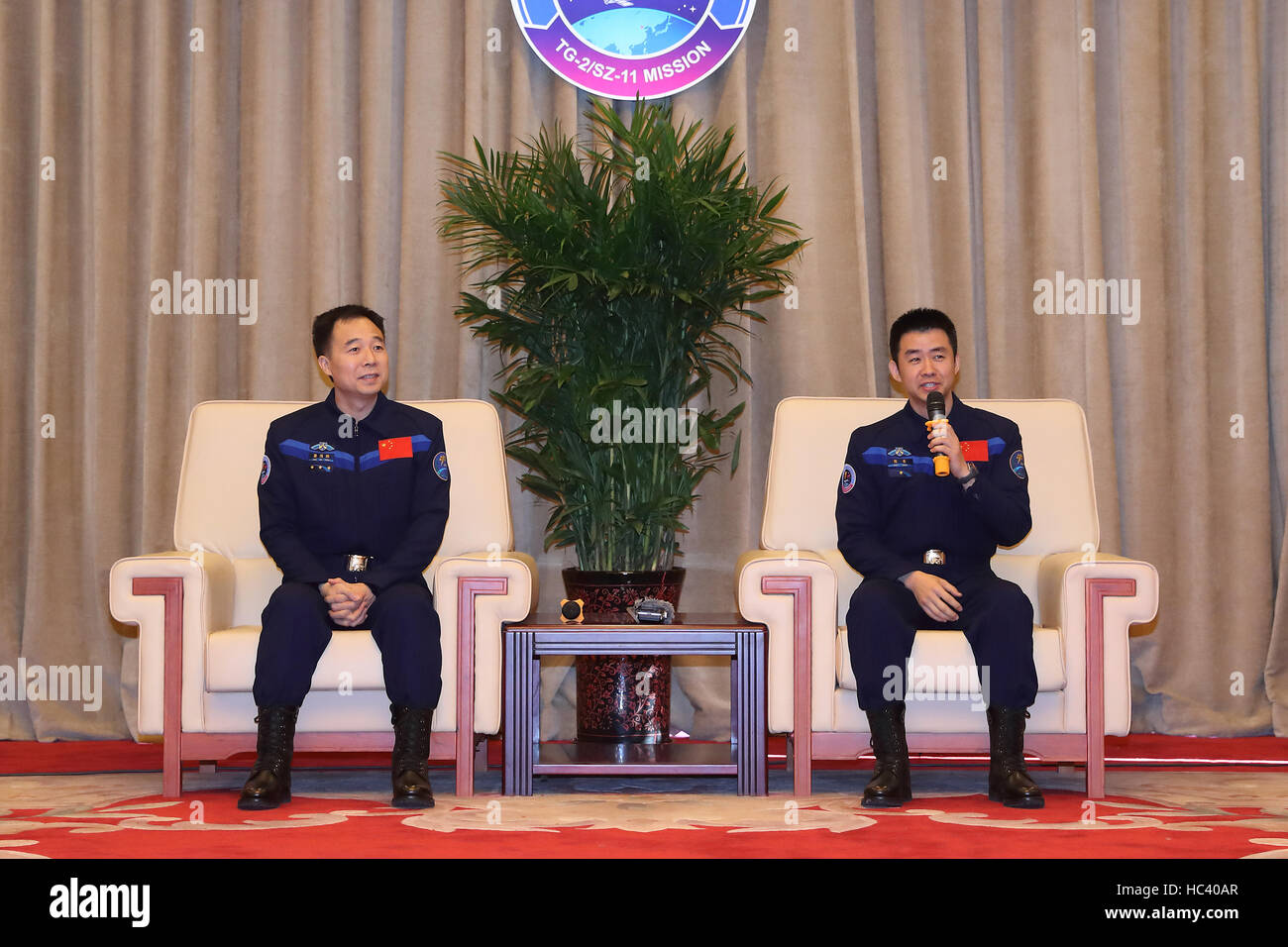 Beijing, China. 7th Dec, 2016. Chinese astronaut Chen Dong (R) answers ...
