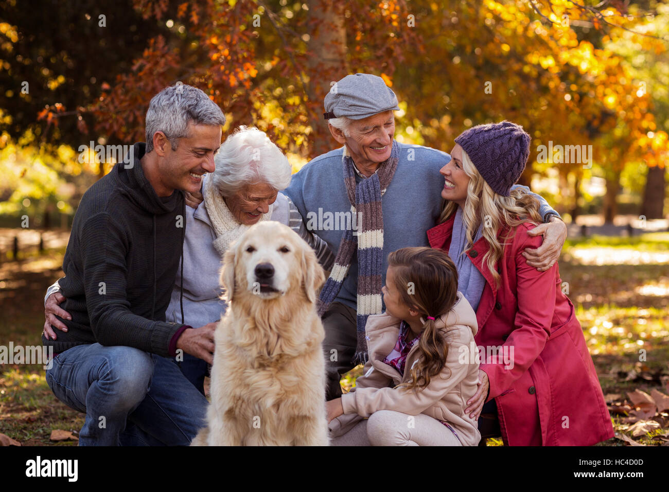 Happy family with dog at park during autumn Stock Photo - Alamy