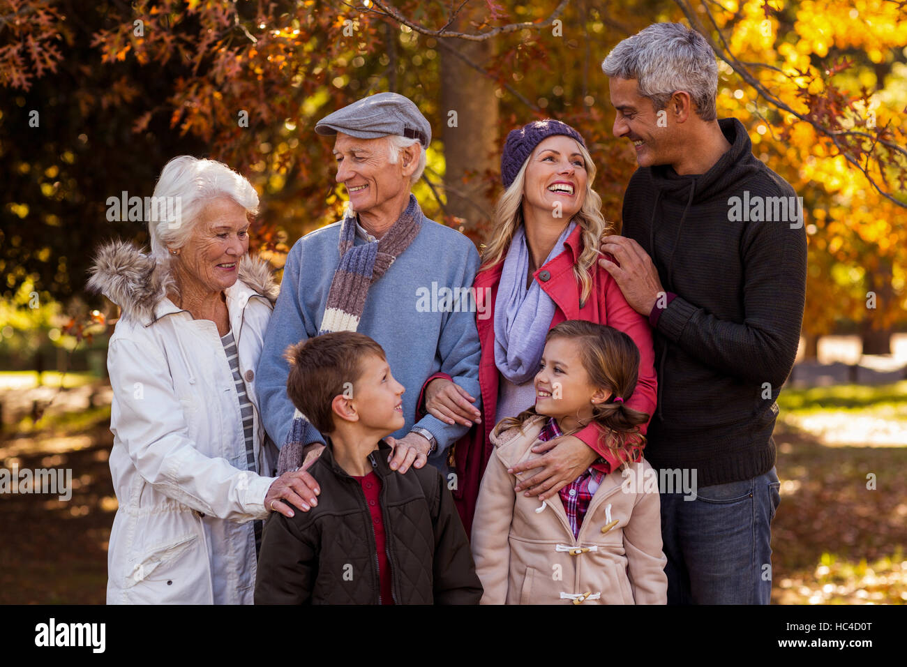Happy multi-generation family standing at park Stock Photo - Alamy