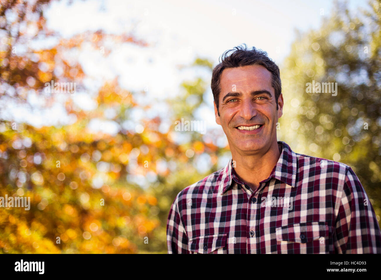 Portrait of happy man at park Stock Photo - Alamy