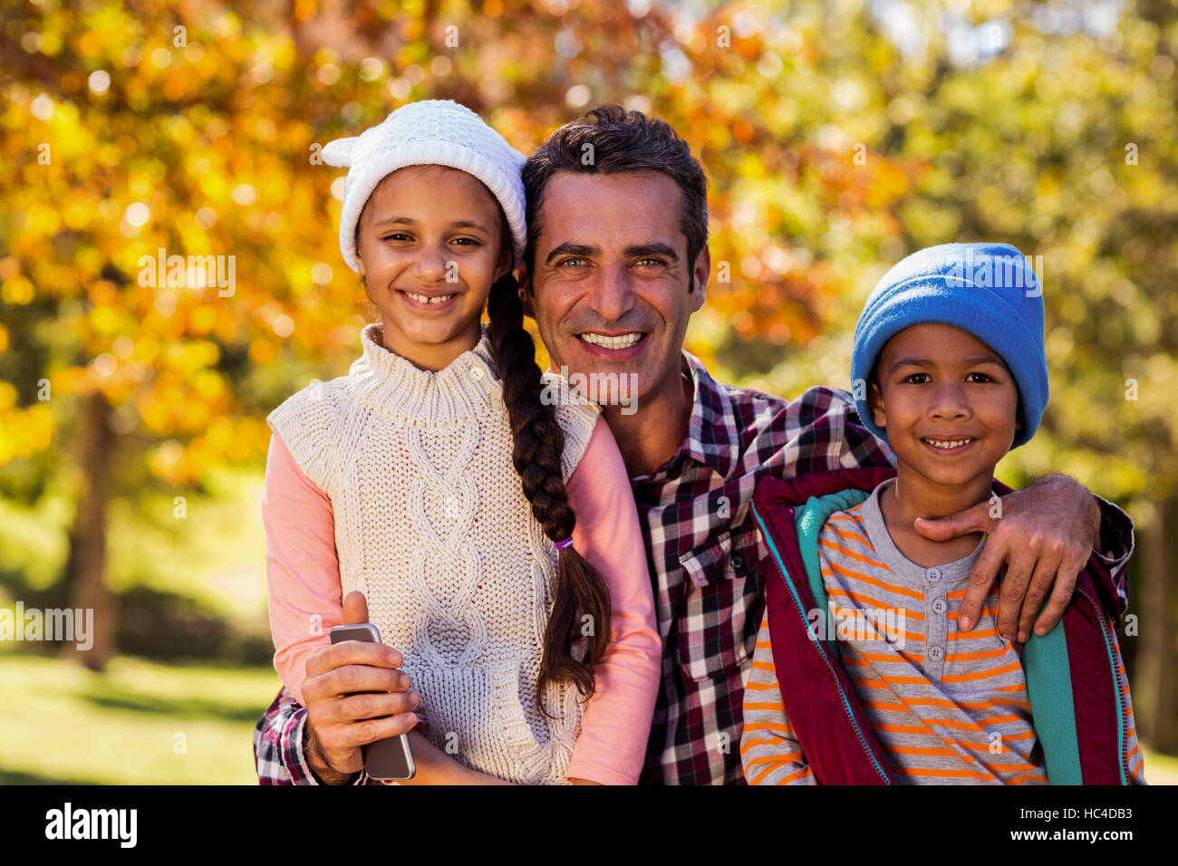 Portrait of father with children at park Stock Photo - Alamy