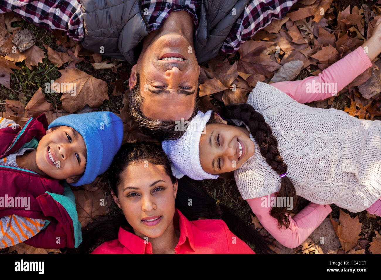 Overhead view of family forming huddle Stock Photo - Alamy