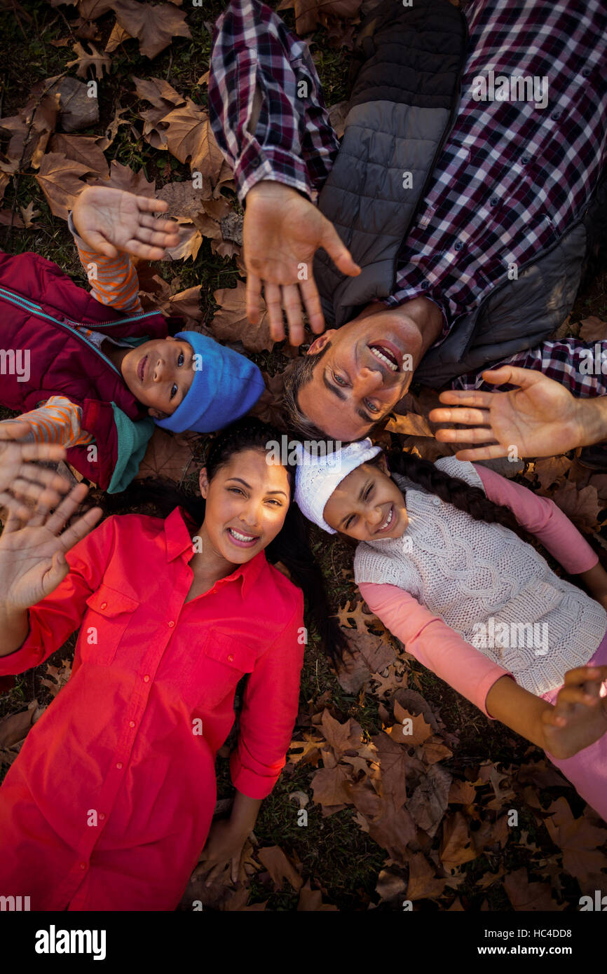 Happy family gesturing while forming huddle Stock Photo - Alamy
