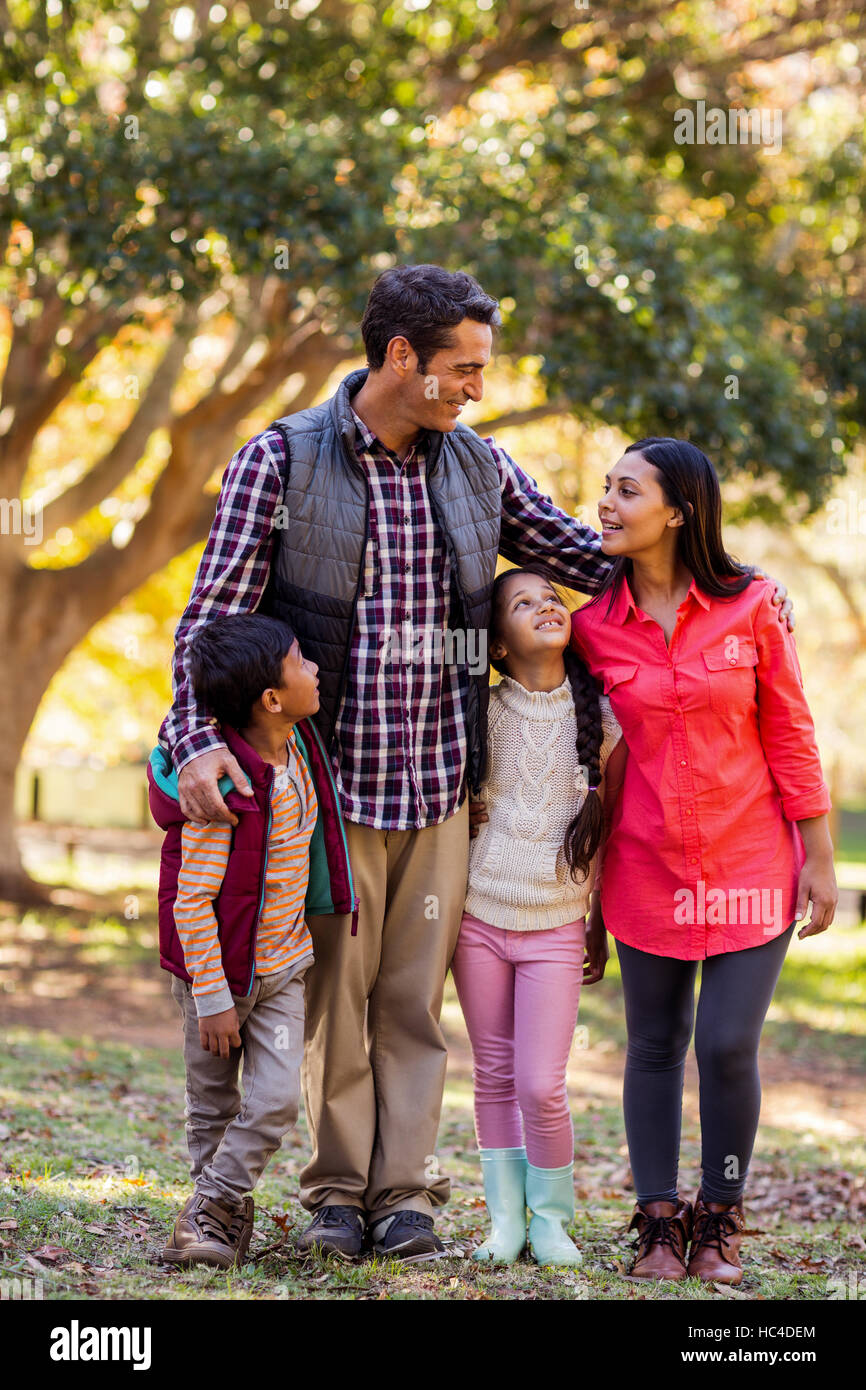 Front view of smiling family standing at park Stock Photo - Alamy