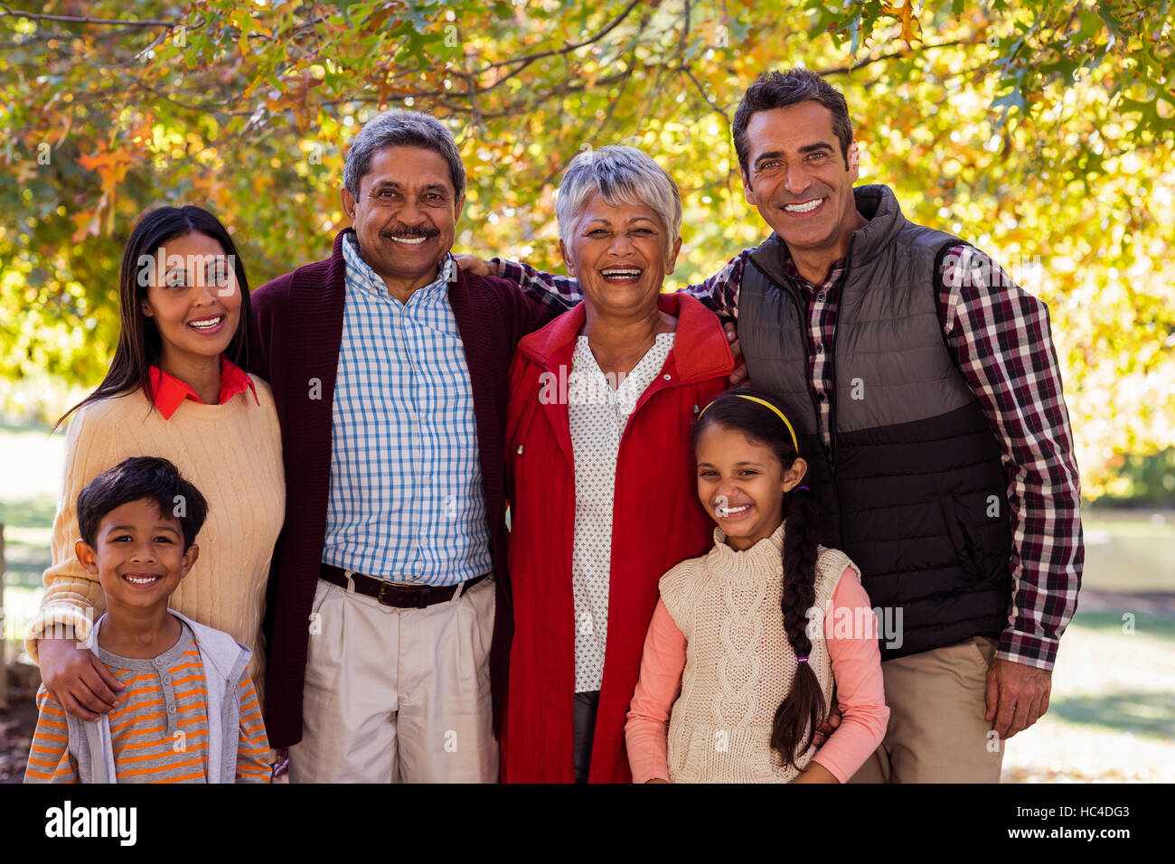 Portrait of multi-generation family standing at park Stock Photo - Alamy