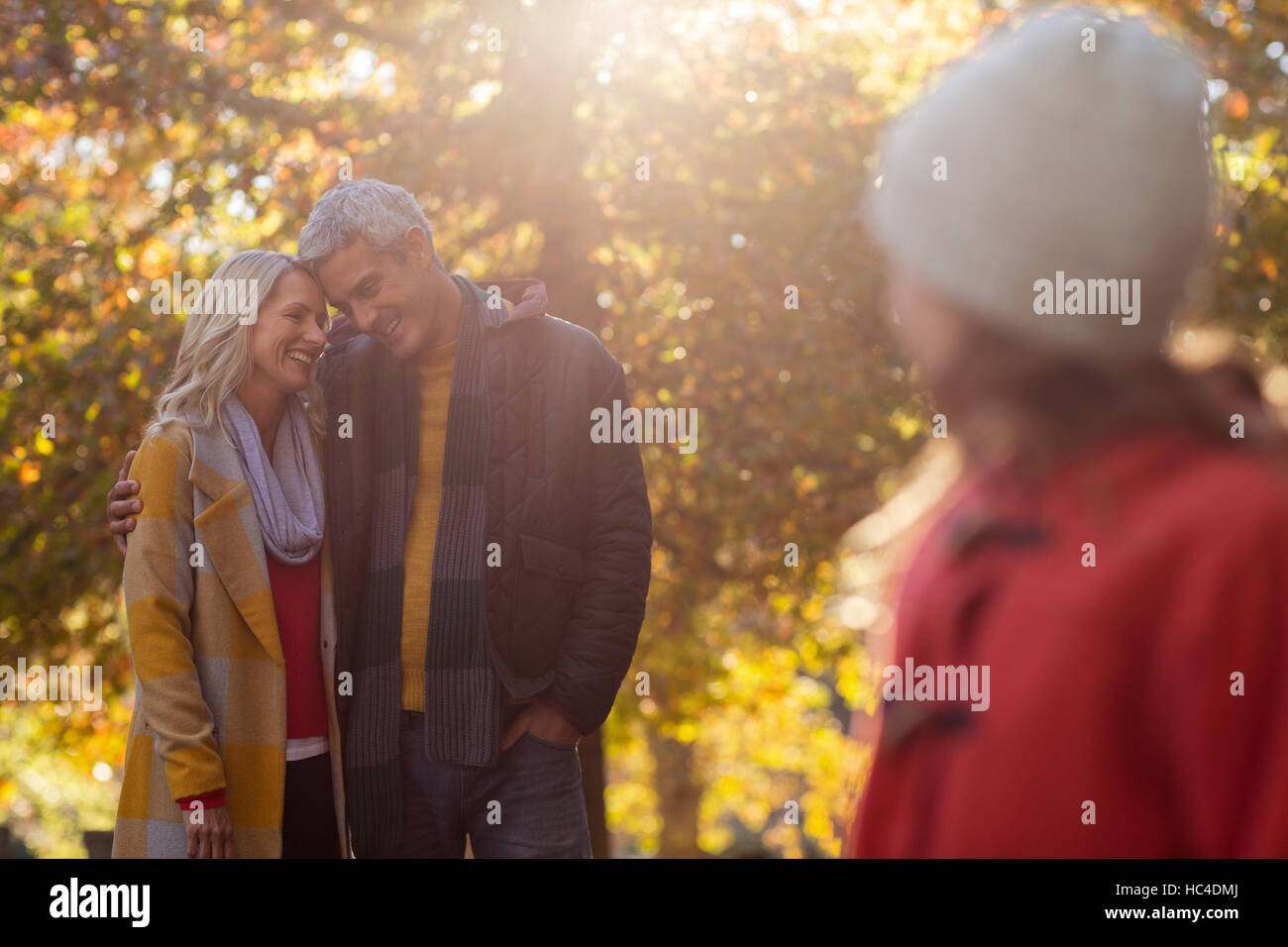 Girl looking towards romantic couple Stock Photo - Alamy