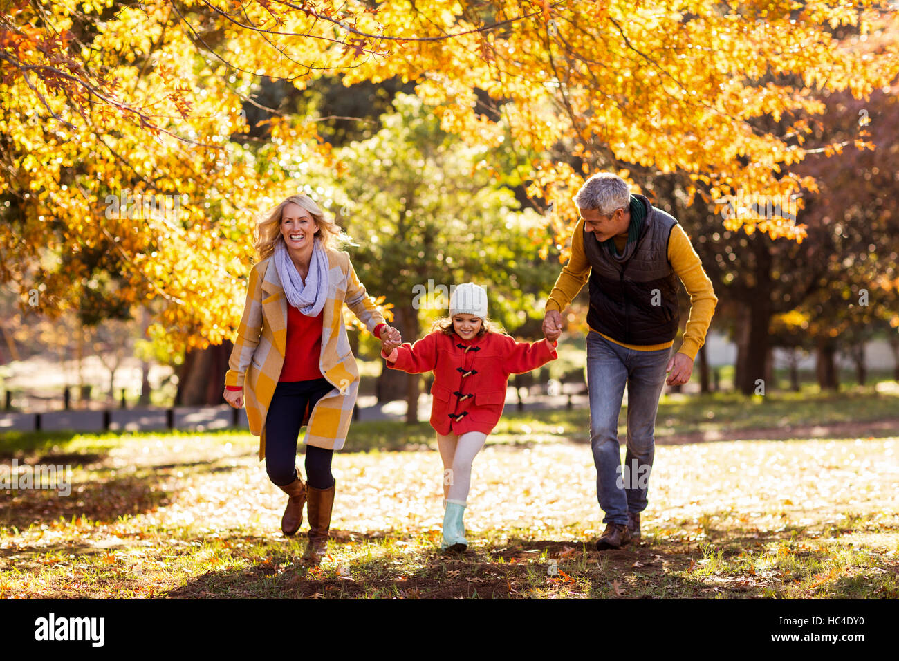 Joyful family walking at park Stock Photo - Alamy
