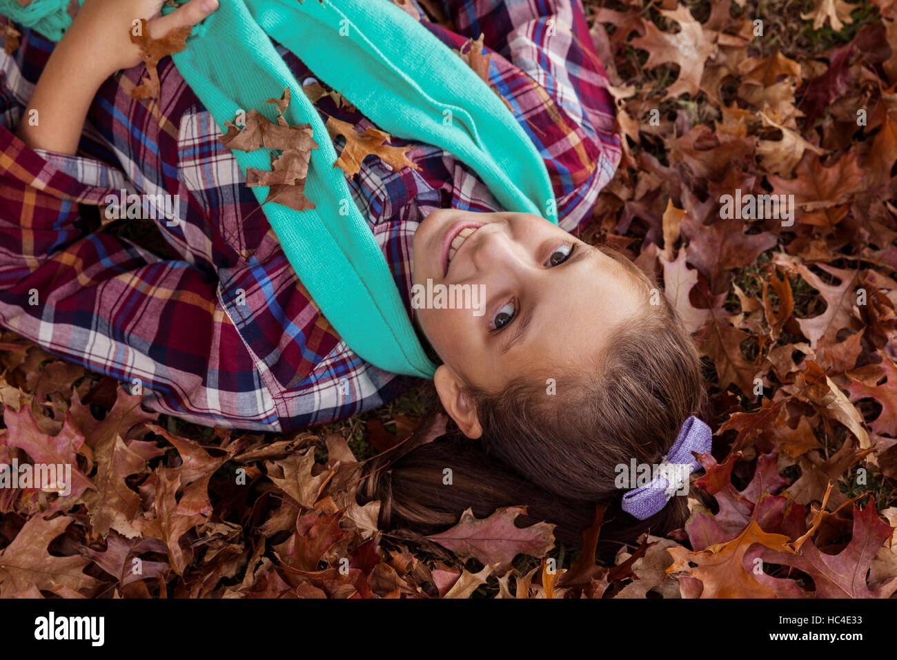 High angle portrait of smiling girl lying at park Stock Photo - Alamy