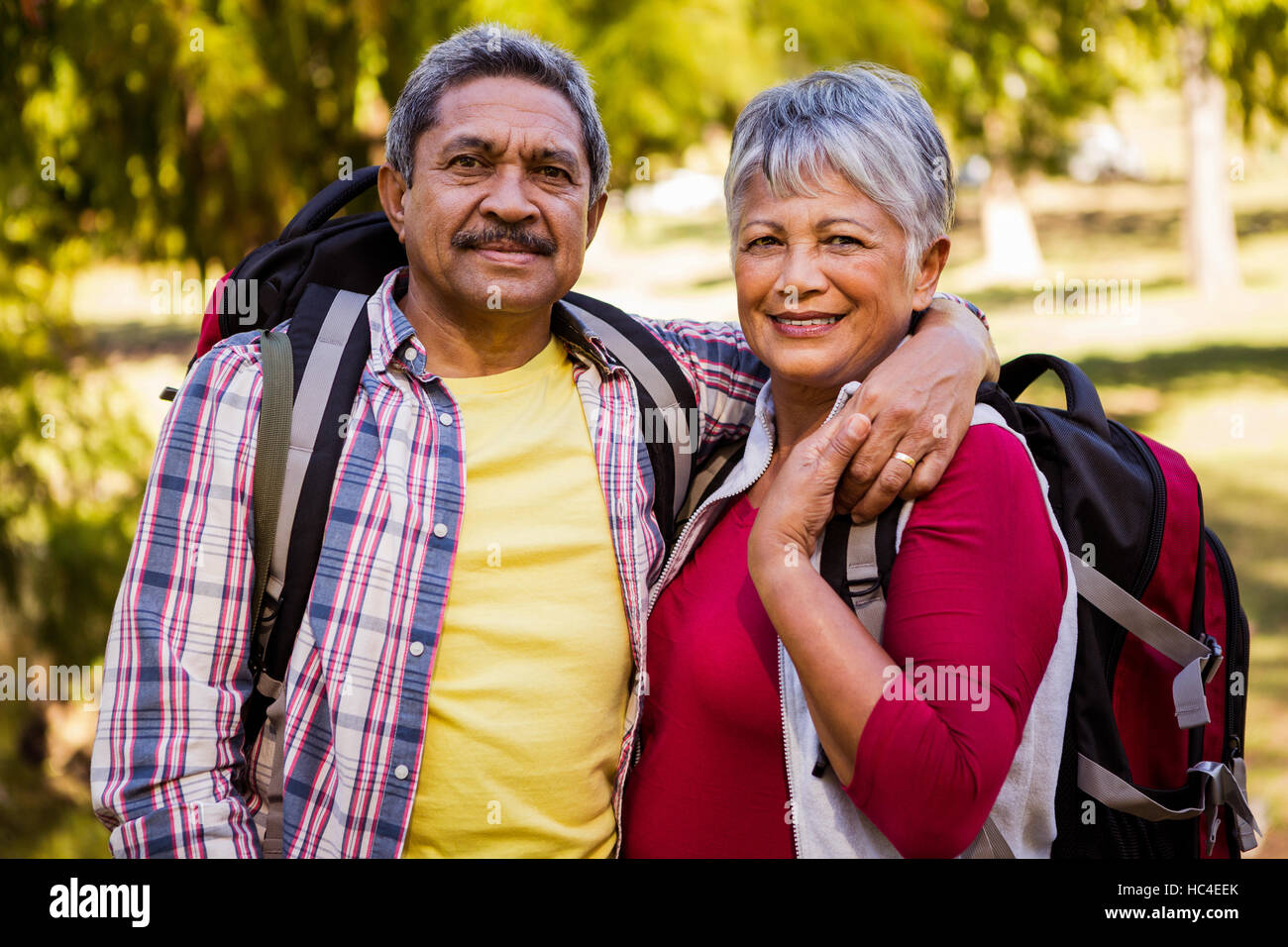 Portrait of hiker couple embracing Stock Photo - Alamy