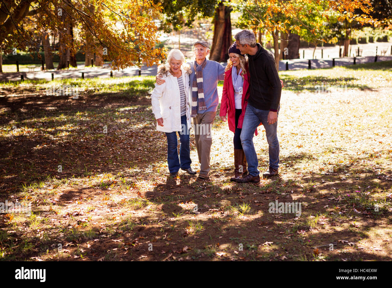 Smiling family walking Stock Photo - Alamy