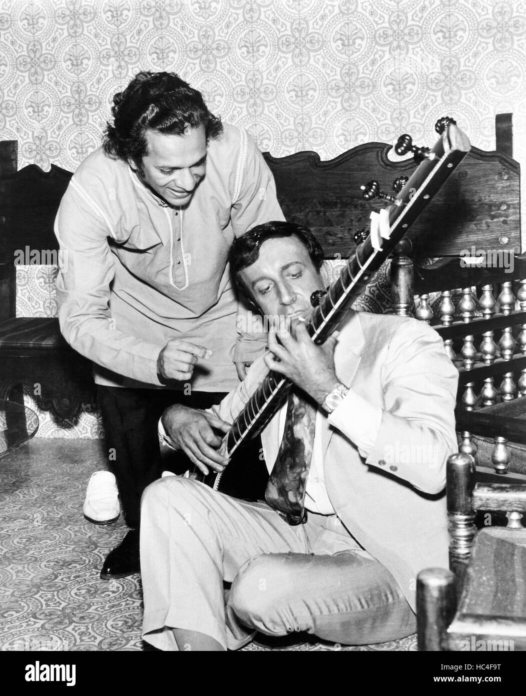 THE PARTY, from left: Ravi Shankar giving some instruction to Peter ...