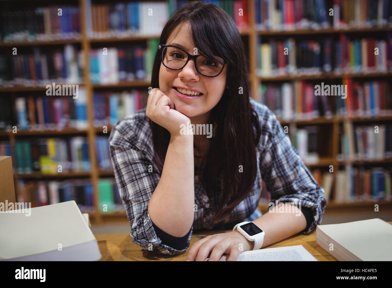 Female student sitting in library Stock Photo - Alamy