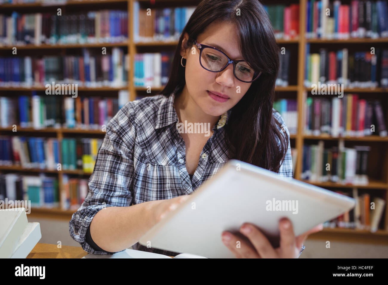 Female student using digital tablet Stock Photo - Alamy