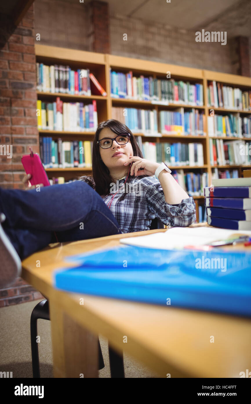 Female student sitting in library with mobile phone Stock Photo - Alamy