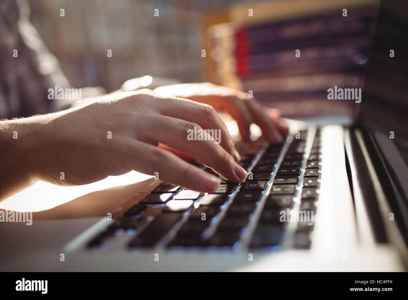 Female student using laptop in library Stock Photo - Alamy