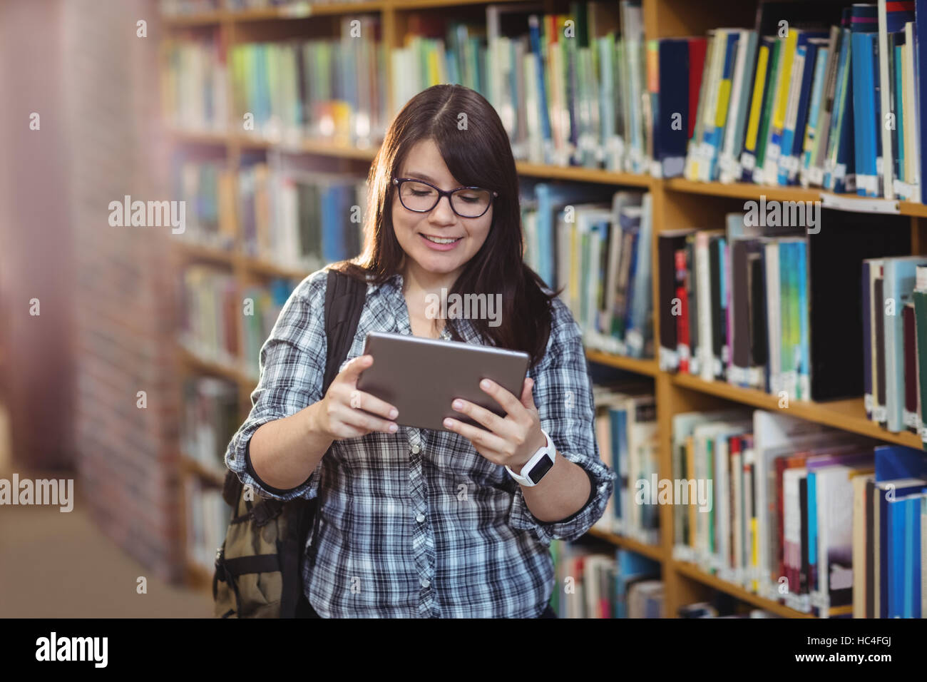 Female student using digital tablet Stock Photo - Alamy
