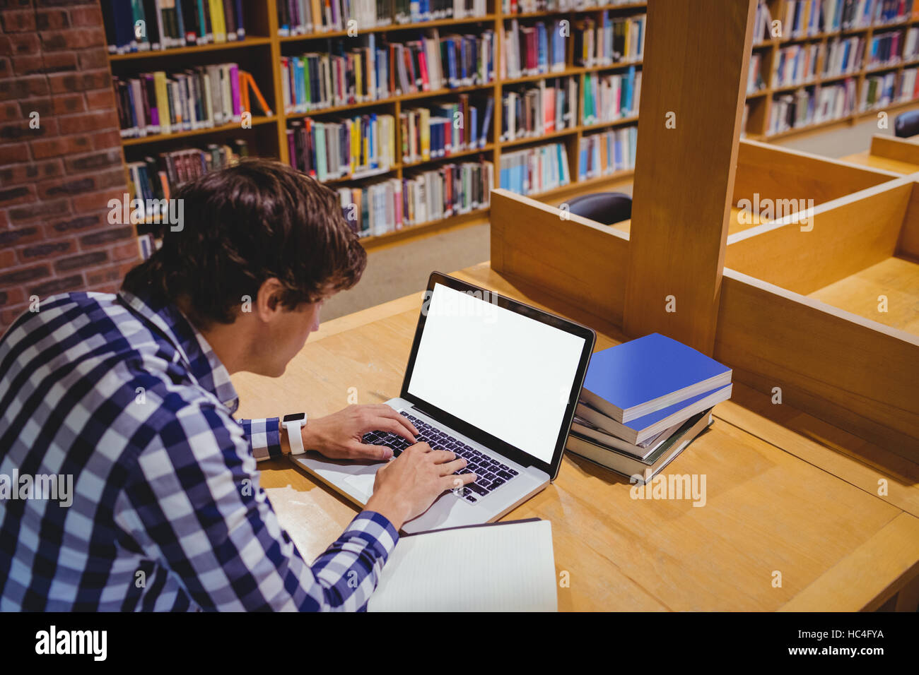 Student using laptop in library Stock Photo - Alamy
