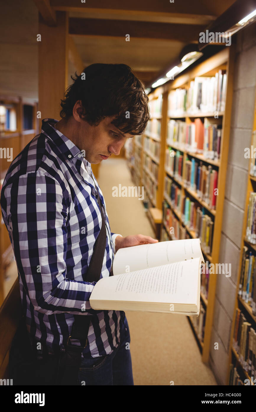 Student reading book in college library Stock Photo - Alamy