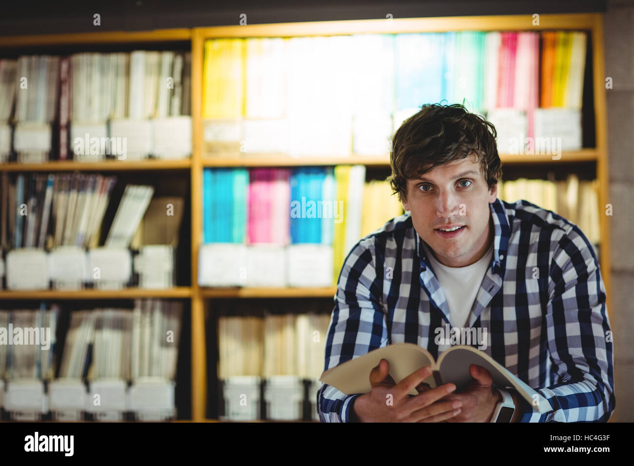 Student reading book in college library Stock Photo - Alamy