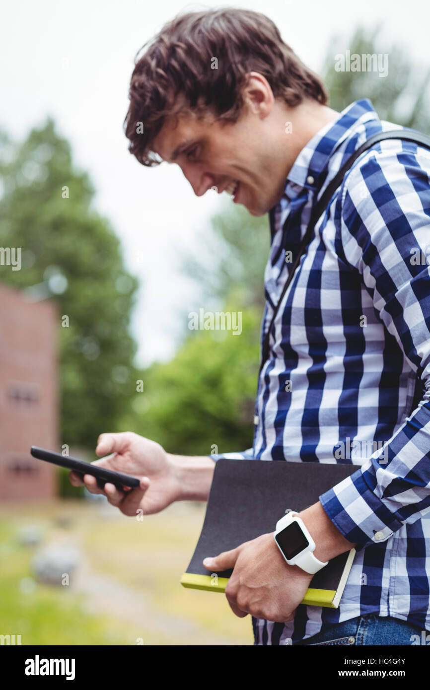 Student using mobile phone in campus Stock Photo - Alamy