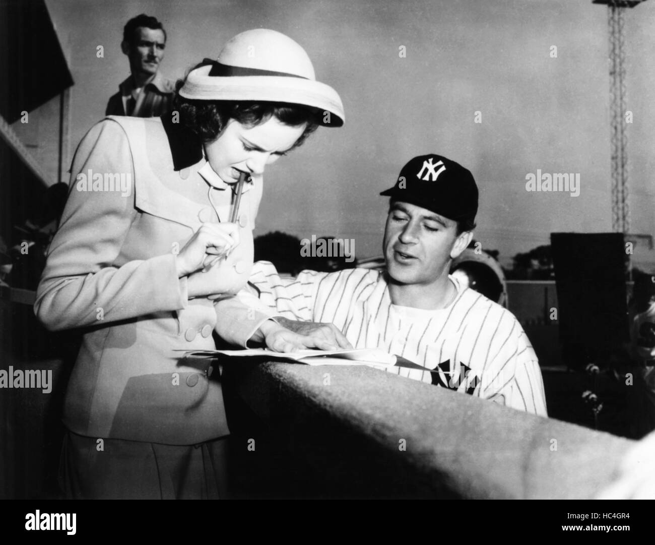 THE PRIDE OF THE YANKEES, from left: Teresa Wright, Gary Cooper reading ...