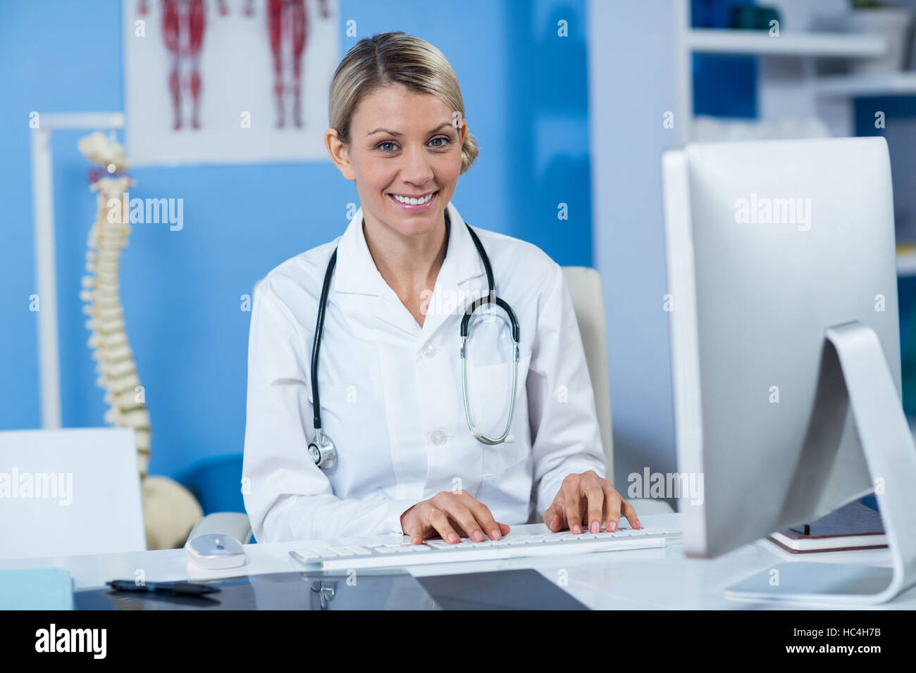 Physiotherapist working on computer Stock Photo - Alamy