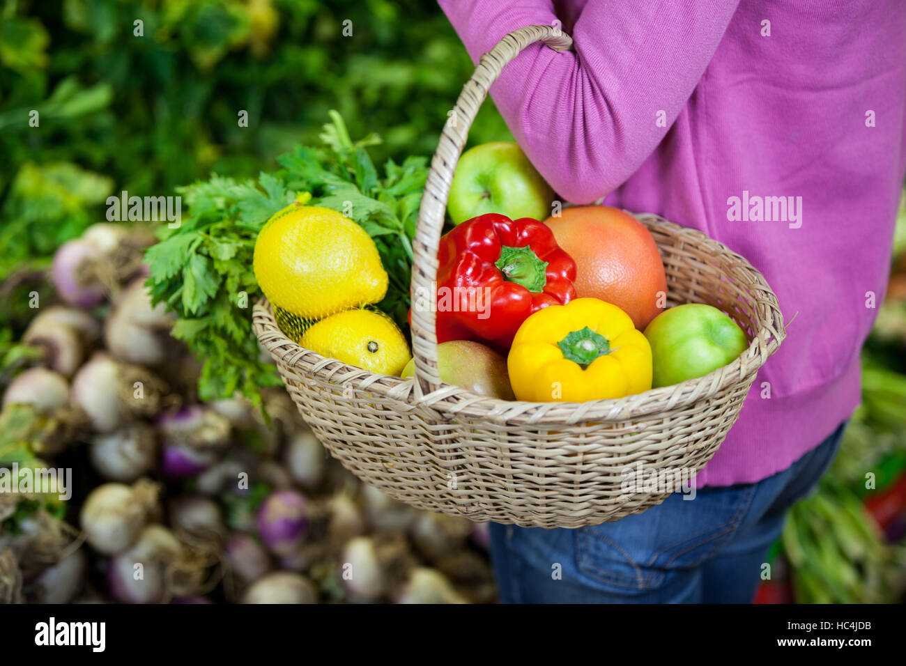 Female shopper holding red basket hi-res stock photography and images ...