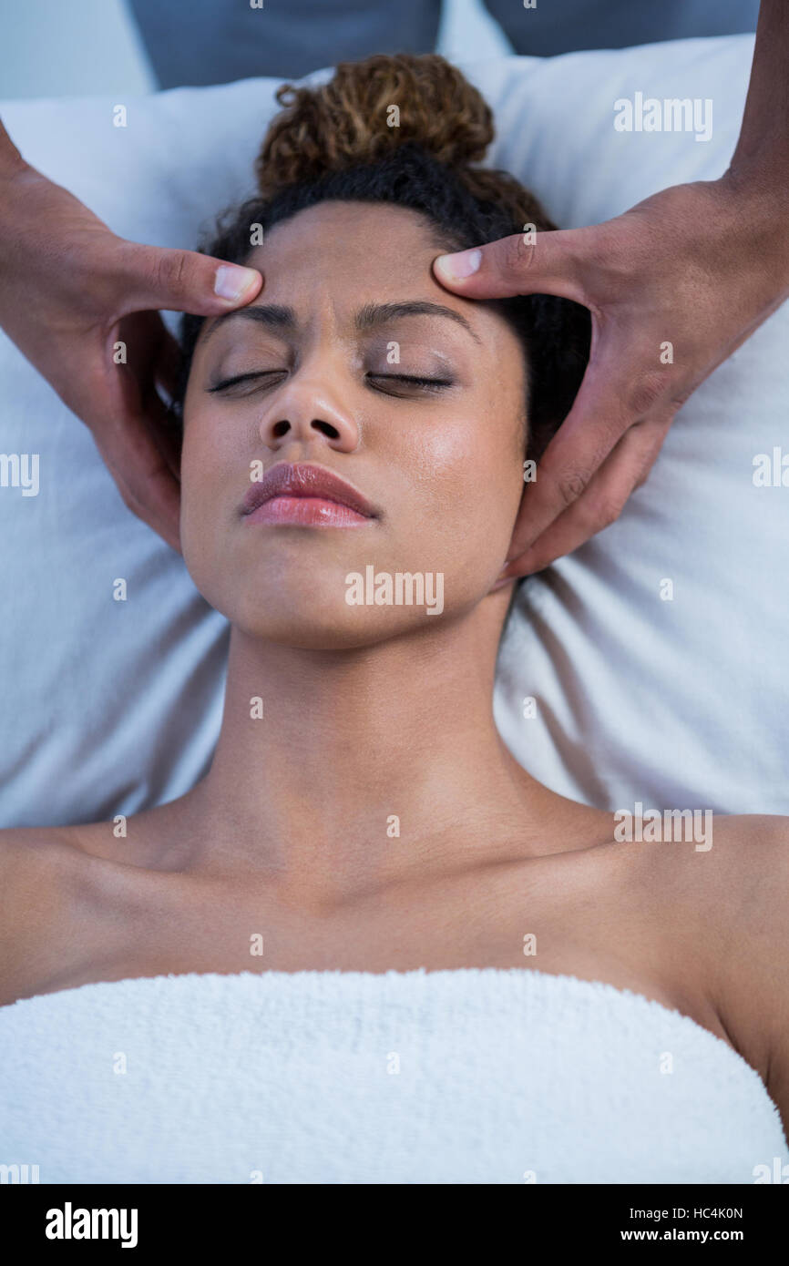 Woman receiving head massage from physiotherapist Stock Photo - Alamy