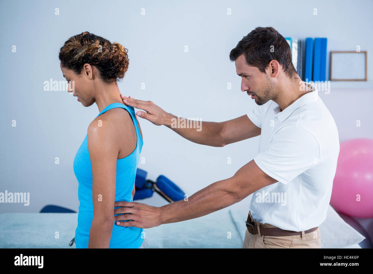Physiotherapist examining womans back Stock Photo - Alamy
