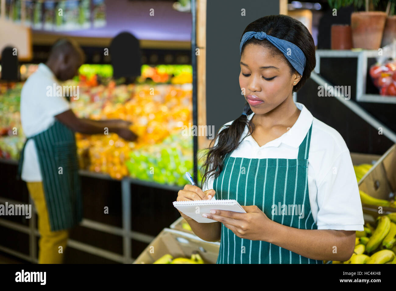 Female staff writing on notepad Stock Photo - Alamy