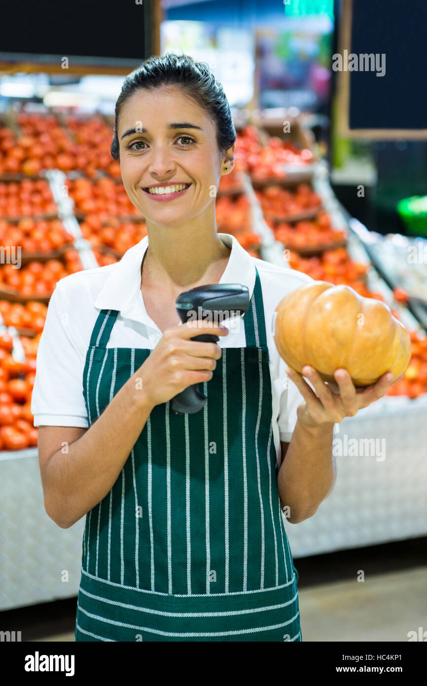 Female staff standing with barcode scanner and pumpkin Stock Photo - Alamy