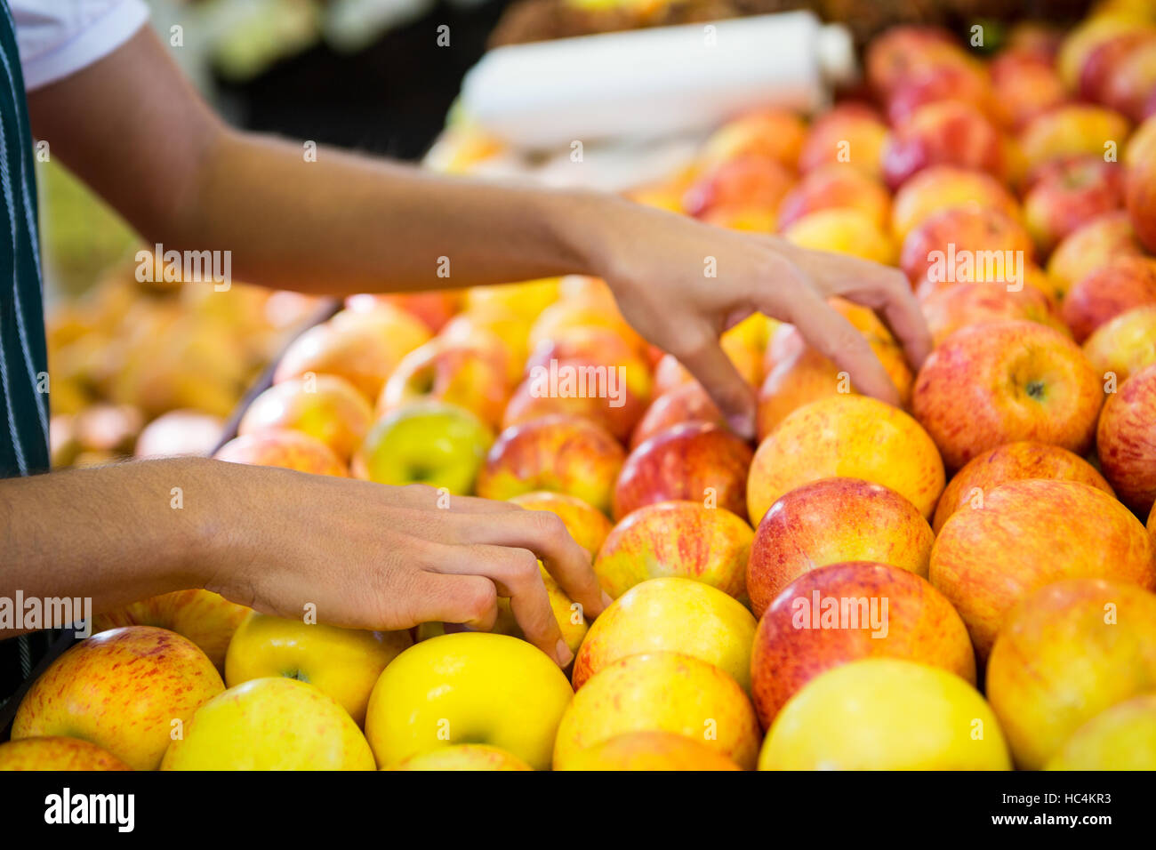 Female staff arranging fruits in organic section Stock Photo - Alamy