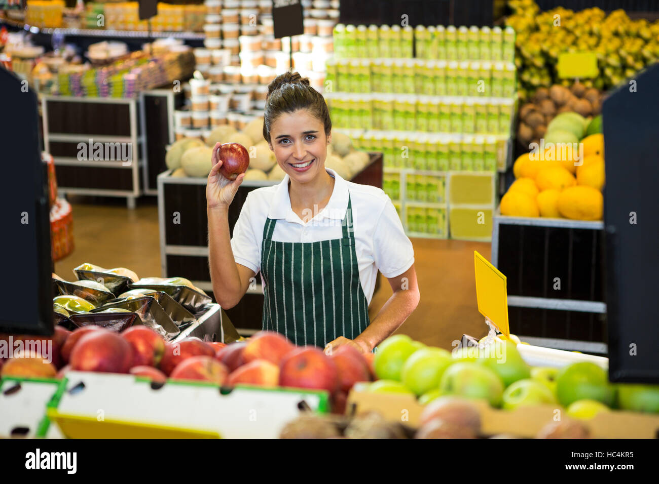 Female staff holding fruit in organic section of supermarket Stock ...