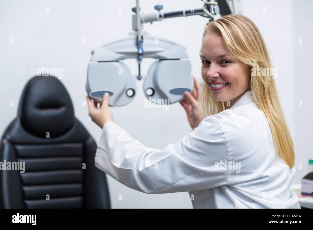 Pretty optometrist smiling camera hi-res stock photography and images ...