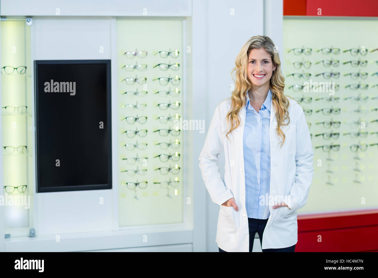 Beautiful optometrist standing in ophthalmology clinic Stock Photo - Alamy