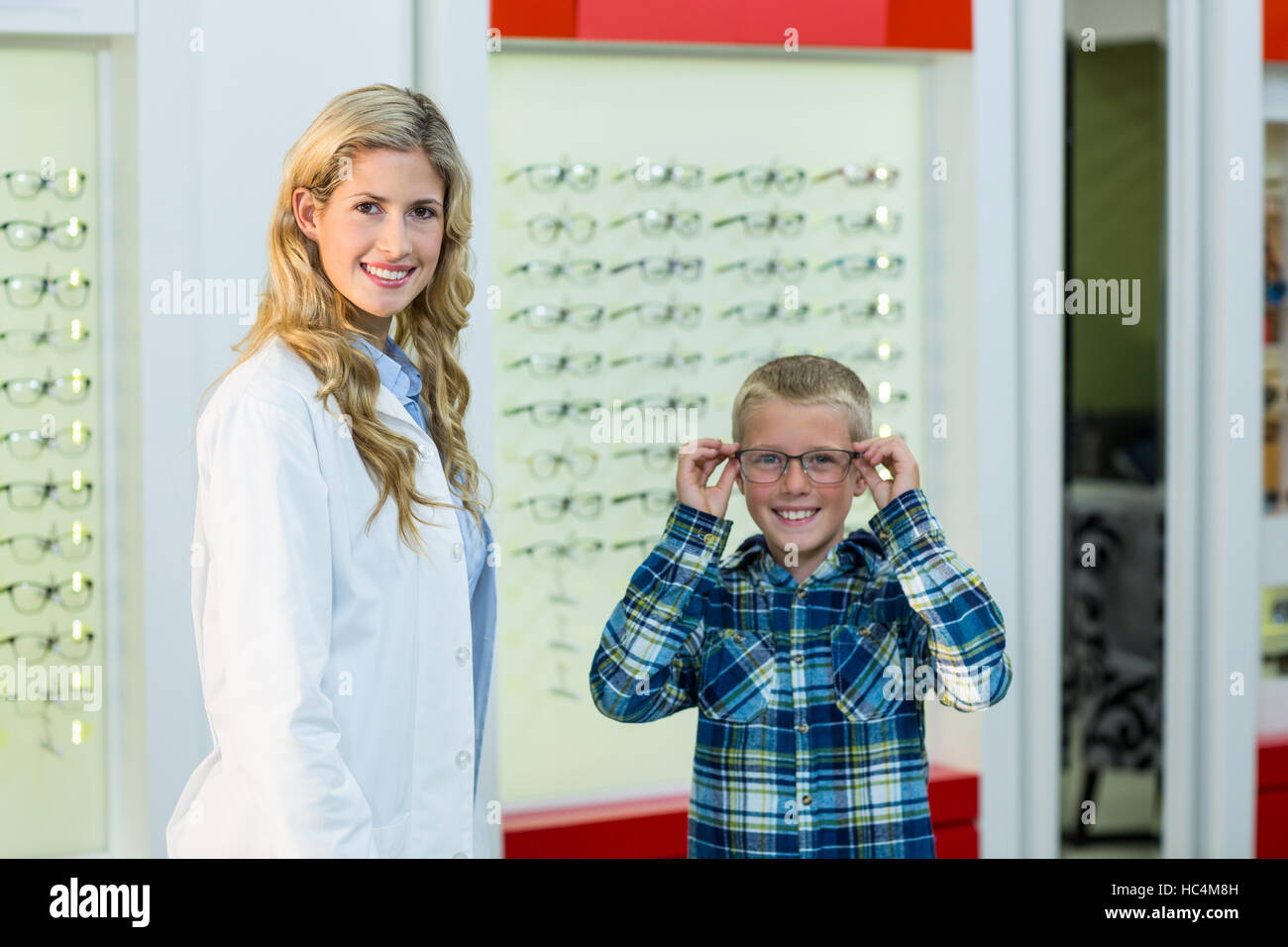 Portrait of female optometrist and young patient Stock Photo - Alamy
