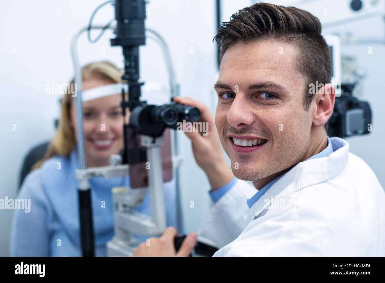 Optometrist examining female patient on slit lamp Stock Photo - Alamy