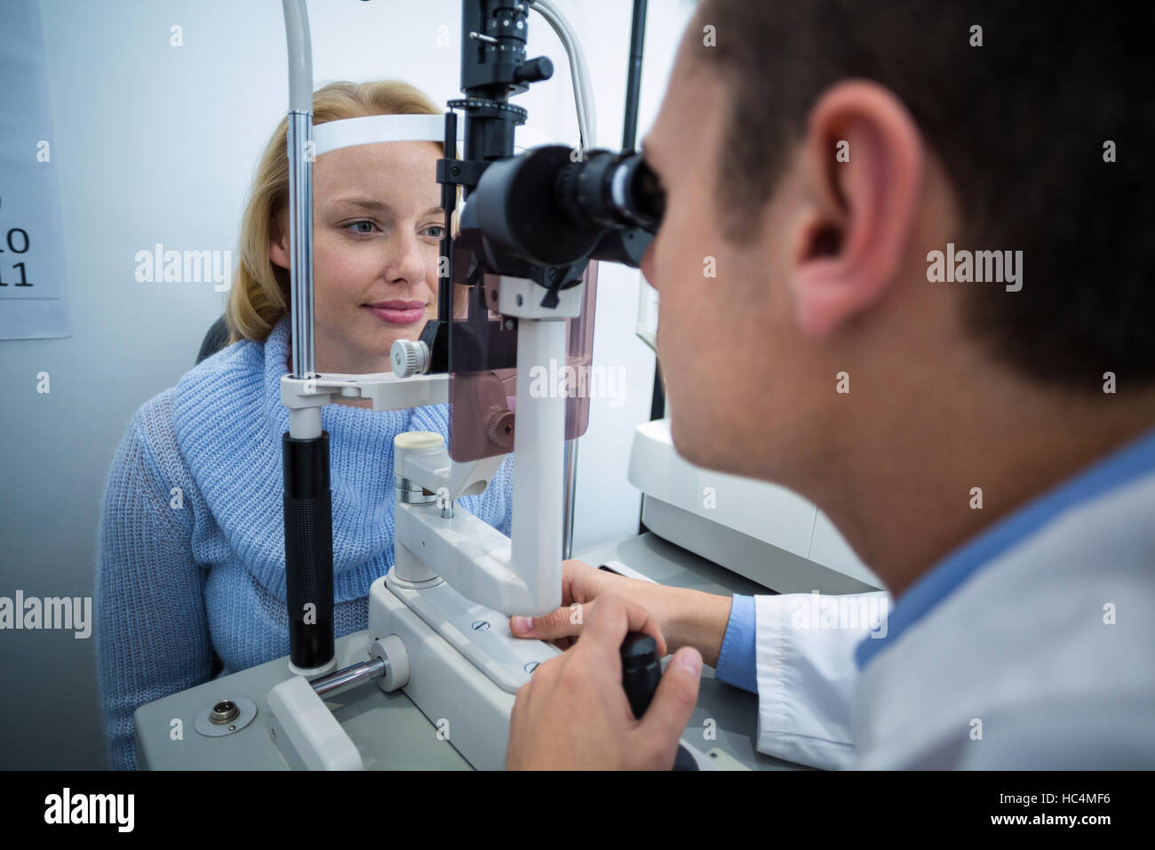 Optometrist examining female patient on slit lamp Stock Photo - Alamy