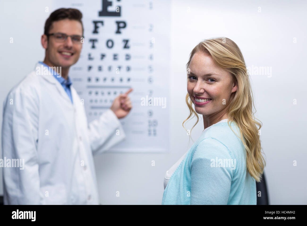 Optometrist taking eye test of female patient Stock Photo - Alamy